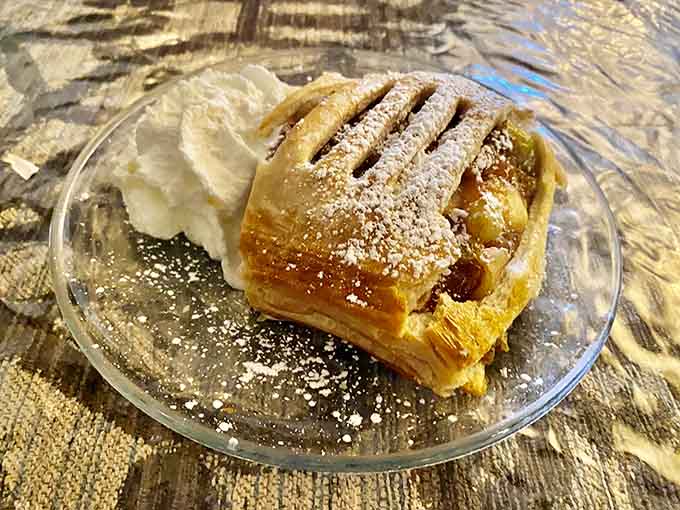 Flaky strudel dusted with powdered sugar, the kind of pastry that makes you understand why people write poetry about dessert.