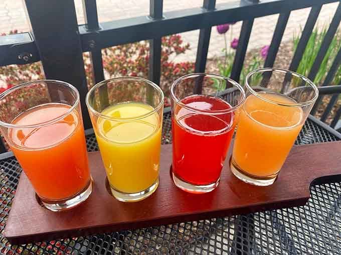 Four colorful mimosas lined up like liquid sunshine, ready to make any meal feel like a celebration worth attending.