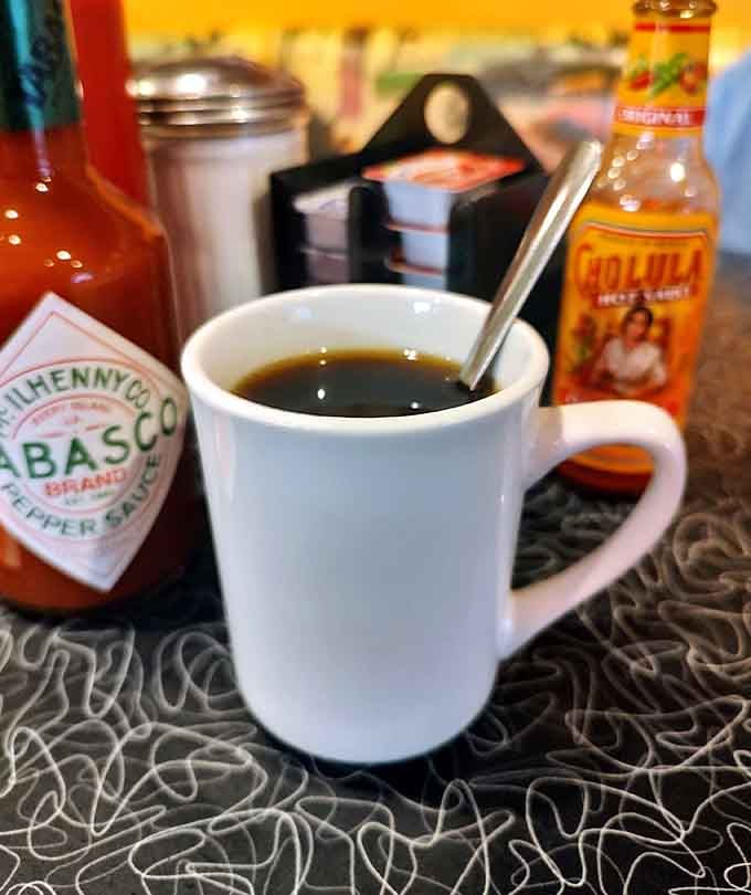 Strong diner coffee in a sturdy mug, ready for unlimited refills and solving the world's problems.