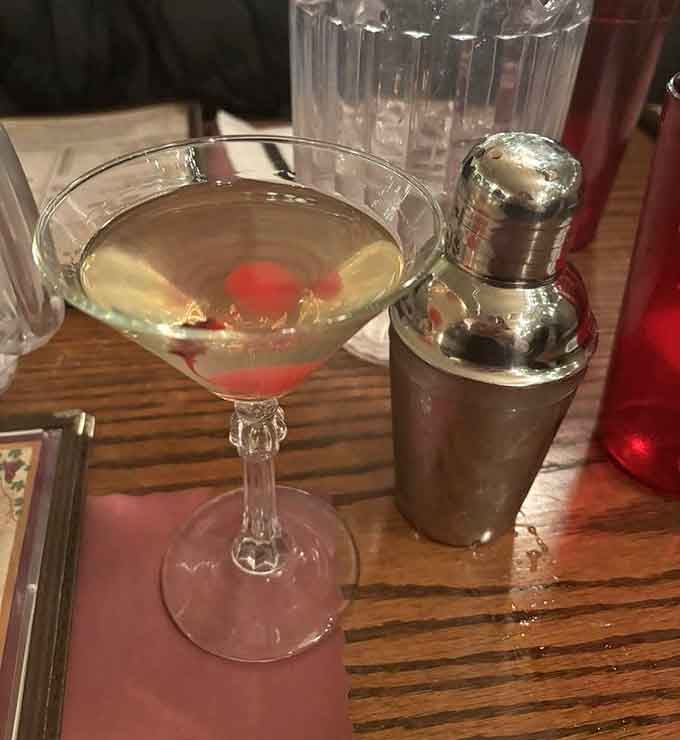 A proper martini with a cherry garnish and vintage shaker nearby, because even pizza joints can class things up when the occasion calls.