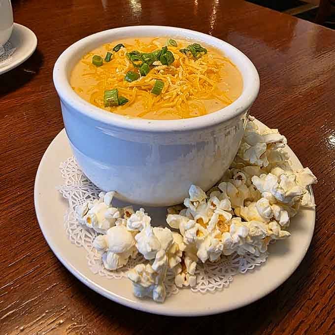 Beer cheese soup topped with cheddar and served with popcorn, because normal garnishes are apparently too boring.