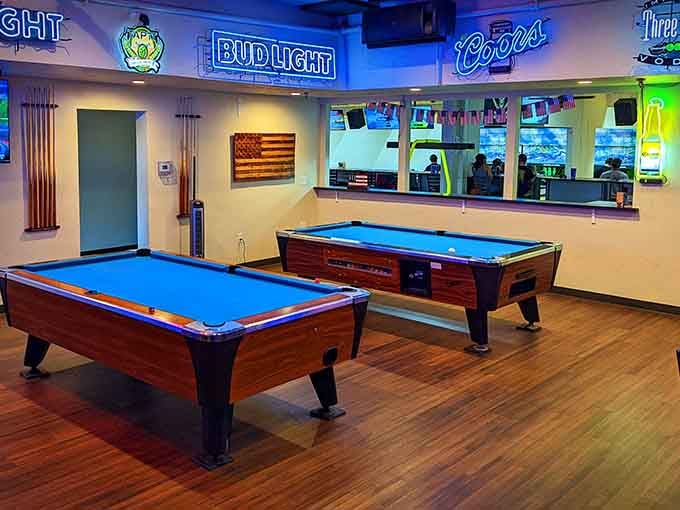 The game room glows with neon beer signs and pool tables, creating the perfect recipe for friendly competition.