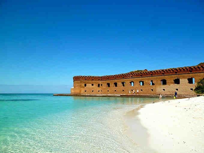 White sand meets brick fortress in a combination that shouldn't work but absolutely does, like peanut butter meeting chocolate.