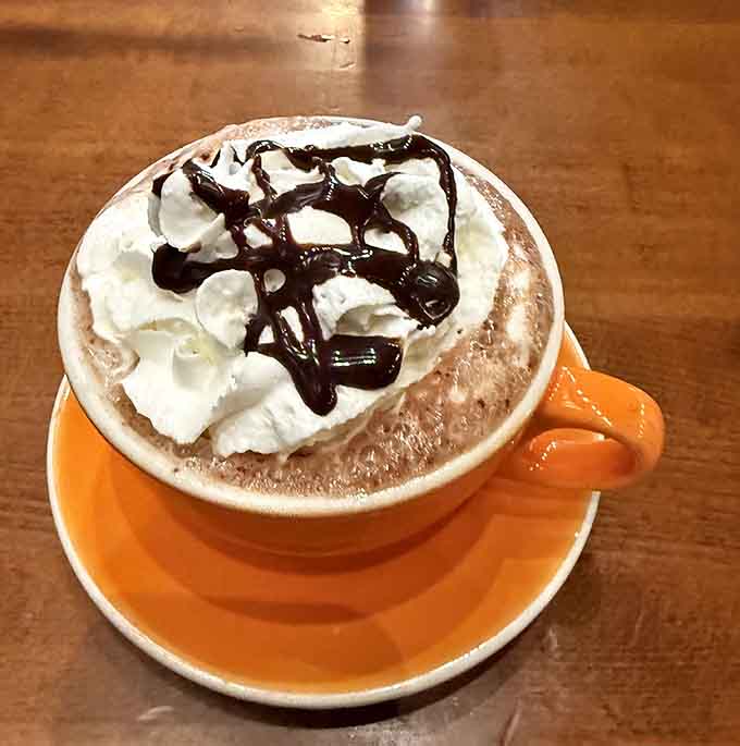 Hot chocolate topped with whipped cream and chocolate drizzle&mdash;because sometimes you need dessert before you've even finished breakfast.