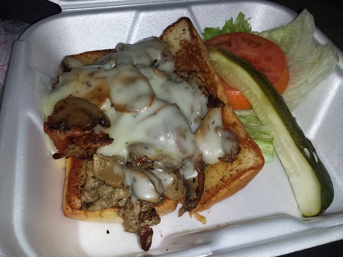 Melted cheese cascading over a Philly cheesesteak like a delicious avalanche you never want to escape from.