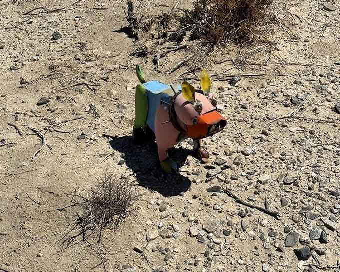 A colorful metal bulldog stands guard, proving that desert watchdogs don't need to be actual living creatures.