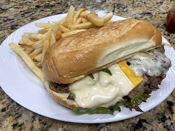 Melted cheese cascades over tender beef like a delicious avalanche you actually want to be caught in, fries included.
