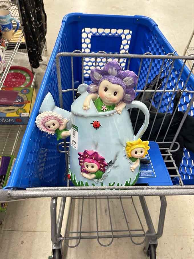 A whimsical ceramic watering can featuring flower-headed characters who look happier than most people before their coffee.