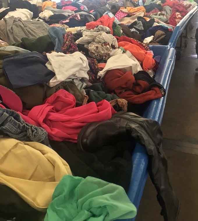 Mountains of clothing await exploration, where designer pieces hide among everyday basics at pennies per pound.