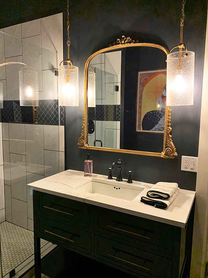 A gilded mirror and dramatic lighting transform your morning routine into something worthy of Downton Abbey's attention.