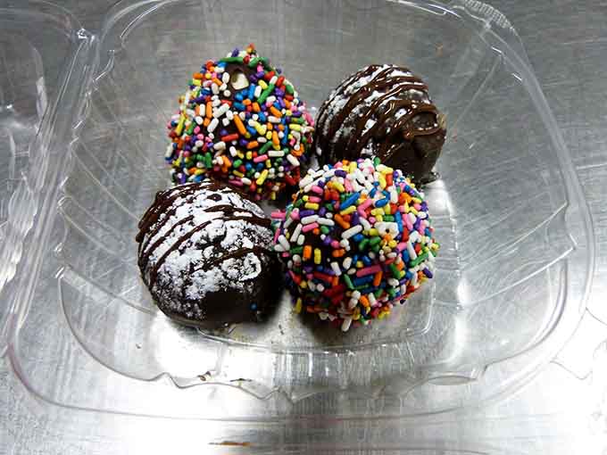 Chocolate truffles dressed up in sprinkles and drizzle, ready to make your day infinitely sweeter with every bite.