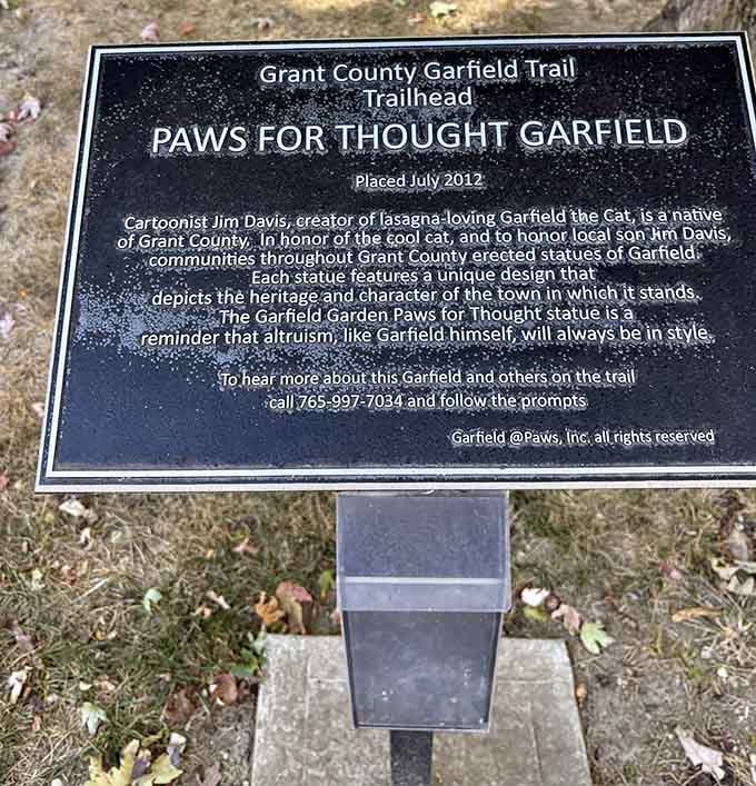 The trailhead marker where your quirky adventure officially begins, paws and all included in the journey.