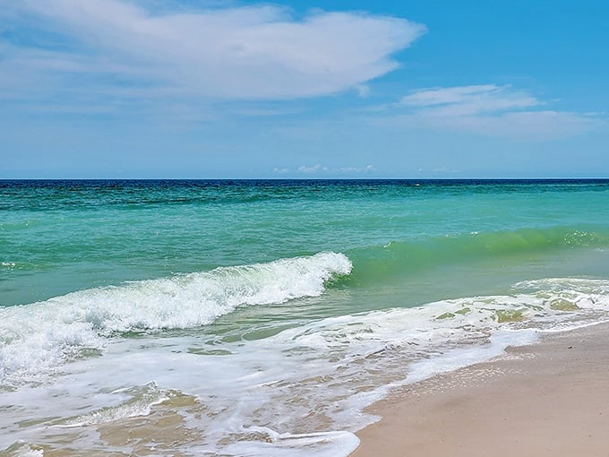That signature emerald-green water rolling onto sugar-white sand creates postcard views you'll actually experience.