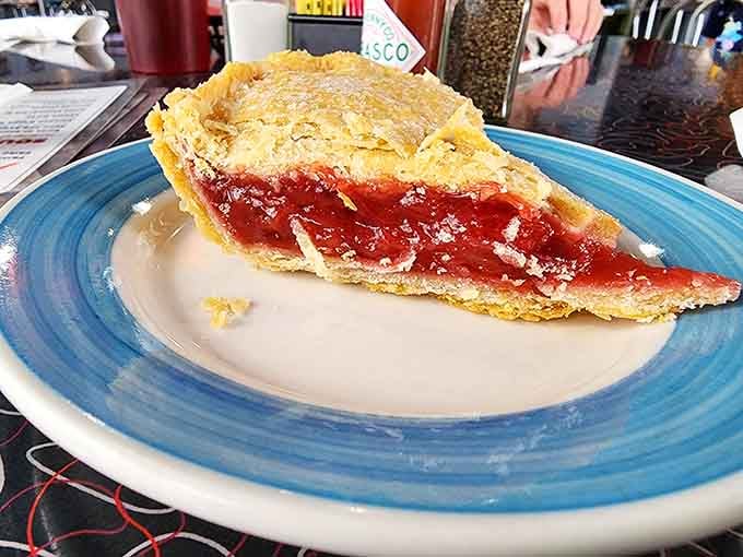 Strawberry rhubarb pie with a lattice crust that looks like grandma made it, assuming your grandma was really good at baking.