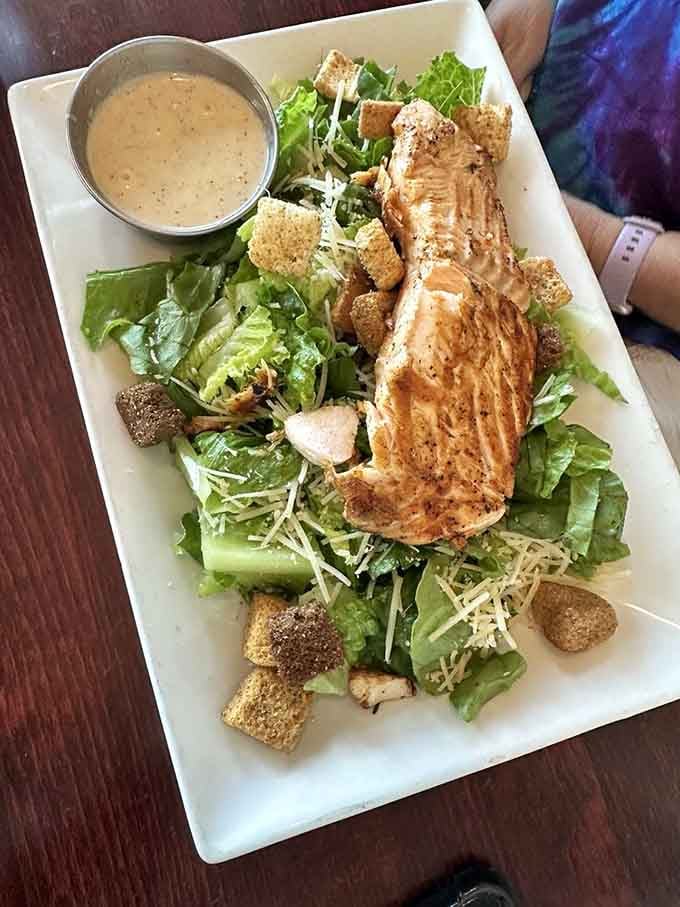 That grilled salmon perched atop crisp Caesar salad is what happens when healthy meets absolutely delicious.
