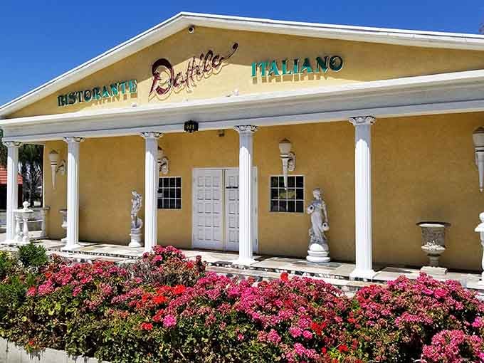 White columns and blooming flowers signal Italian dining where the ambiance matches the menu's Mediterranean roots.