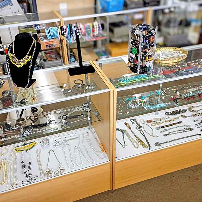 Jewelry cases gleaming with possibilities, where vintage treasures hide among everyday pieces waiting for discovery by sharp eyes.