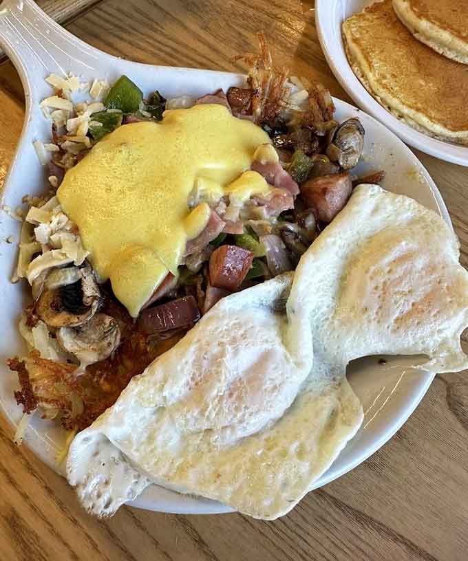Hollandaise-draped hash and ham topped with eggs: breakfast never looked this photogenic or tasted this good.