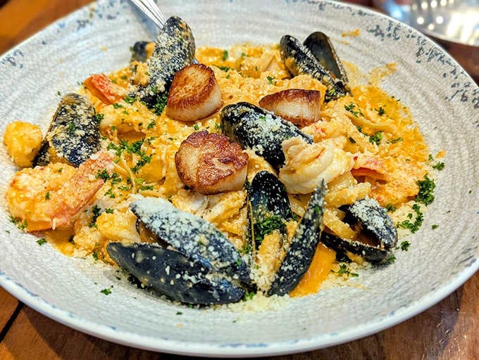 This pasta dish brings together scallops, mussels, and enough seafood to stock a small aquarium, minus the water and fish food.