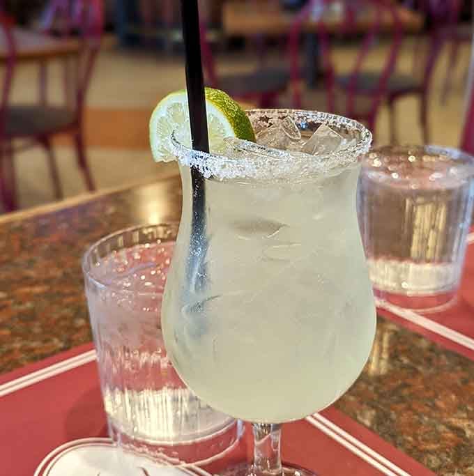 A perfectly crafted margarita with a salt rim that sparkles like tiny diamonds around your afternoon happiness.
