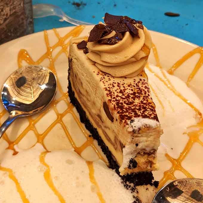 This cheesecake slice with caramel drizzle and chocolate shavings is the sweet ending your meal has been building toward.