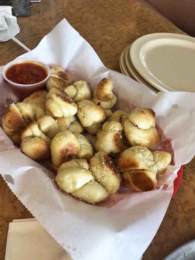 Golden-brown garlic knots that look like they were tied by someone who actually cares about your carbohydrate-based happiness today.