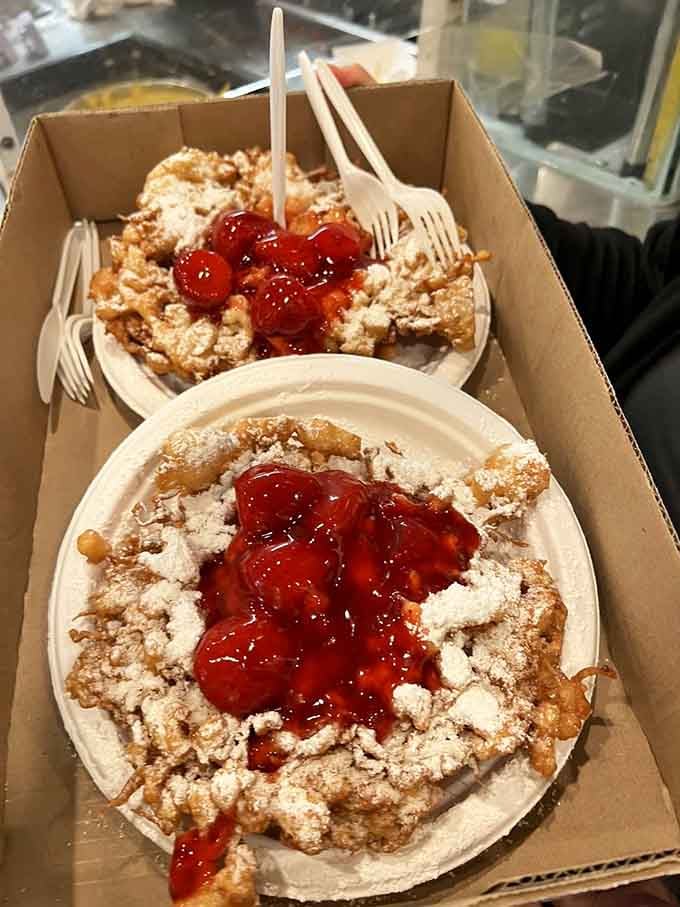 Funnel cakes topped with strawberries and powdered sugar, bringing the carnival straight to your taste buds daily.