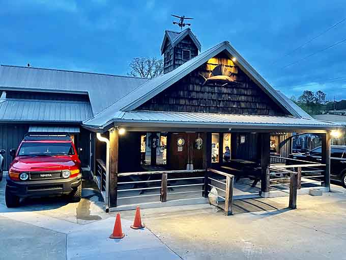 Evening lights transform this rustic building into the kind of cozy gathering place that makes you forget about your phone entirely.