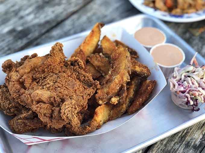 A platter of golden fried chicken and crispy potatoes that could make a vegetarian reconsider their life choices, temporarily.