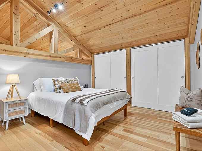 Exposed beams and crisp white linens in this upstairs bedroom blend rustic charm with the comfort your aching bones deserve.