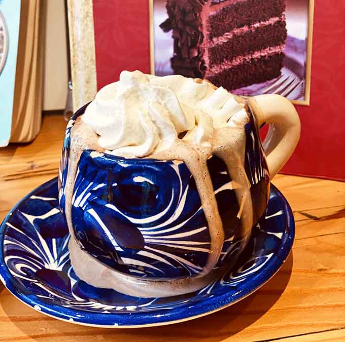 This hot chocolate topped with whipped cream and drizzle is basically a hug in a decorative mug.
