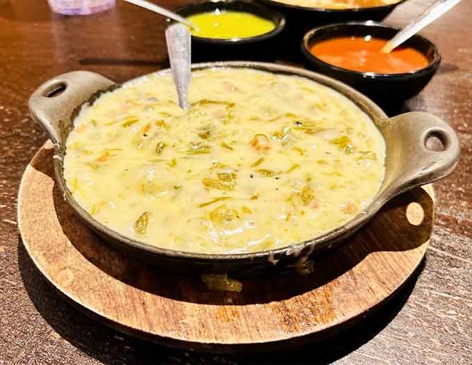 Chile con queso bubbling in a cast iron skillet is basically liquid gold, and yes, you'll want extra chips.