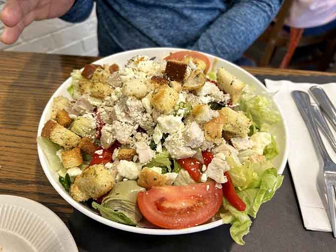 Mediterranean chicken salad piled high with homemade croutons, feta, and fresh vegetables that actually taste like vegetables.