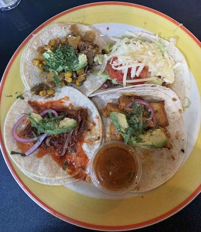 Four tacos loaded with different fillings on one plate means you never have to choose just one favorite, thank goodness.