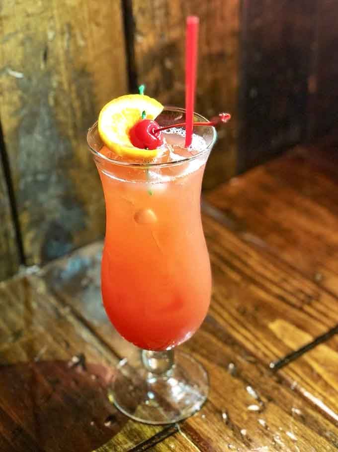 A Hurricane-style cocktail garnished with citrus and cherry brings French Quarter vibes straight to your Michigan table today.
