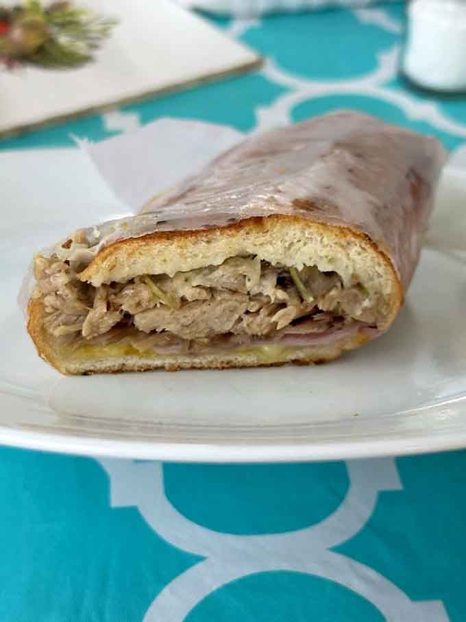 The Cuban sandwich: layers of pork, ham, and cheese pressed into portable perfection you can't resist.
