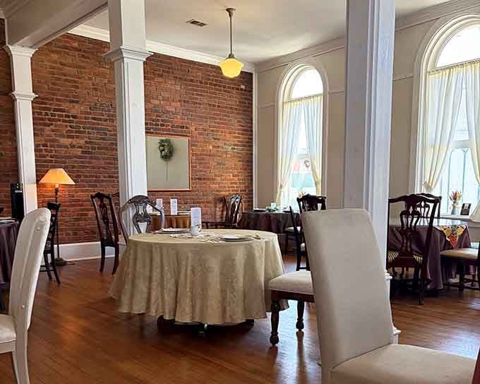 Exposed brick walls and elegant arched windows create an atmosphere that's both historic and utterly welcoming inside.
