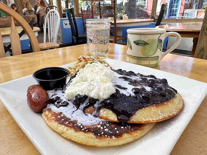 Blueberry pancakes topped with whipped cream and bacon, proving that breakfast really can be a work of art.