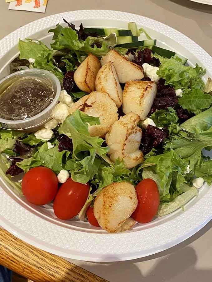 Fresh greens topped with perfectly seared scallops turn a simple salad into something worth writing home about immediately.