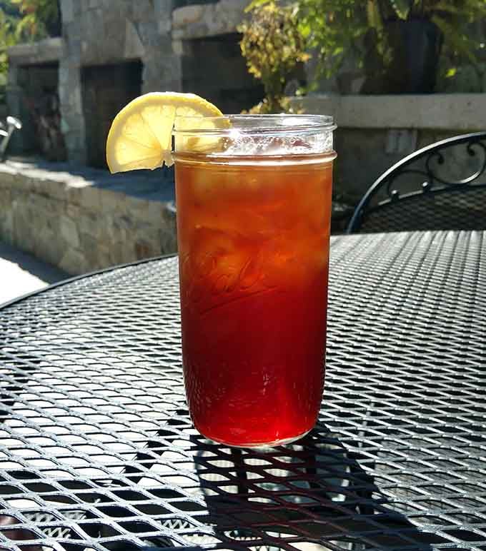Sweet tea with a lemon wedge, sitting pretty on the patio where good decisions are made daily.