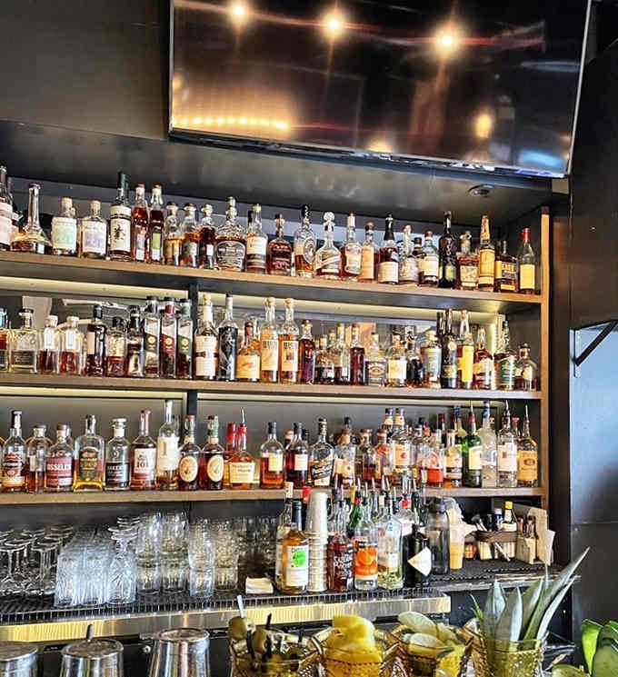 The whiskey wall displays bottles like liquid gold, offering everything from familiar favorites to adventurous new discoveries for enthusiasts.