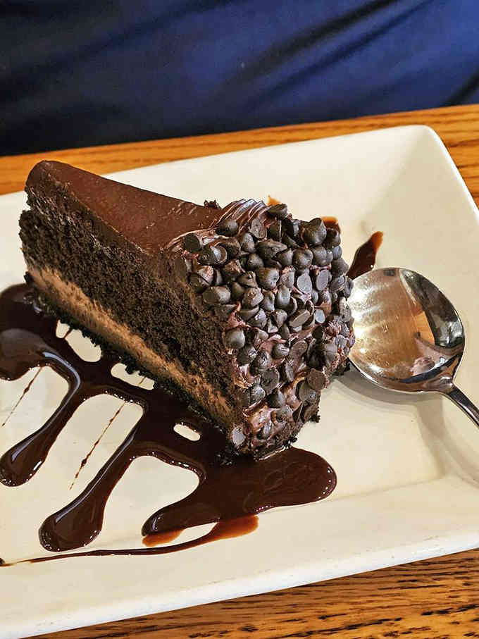 Chocolate cake that's basically a tower of joy, proving dessert stomachs are real and expandable.