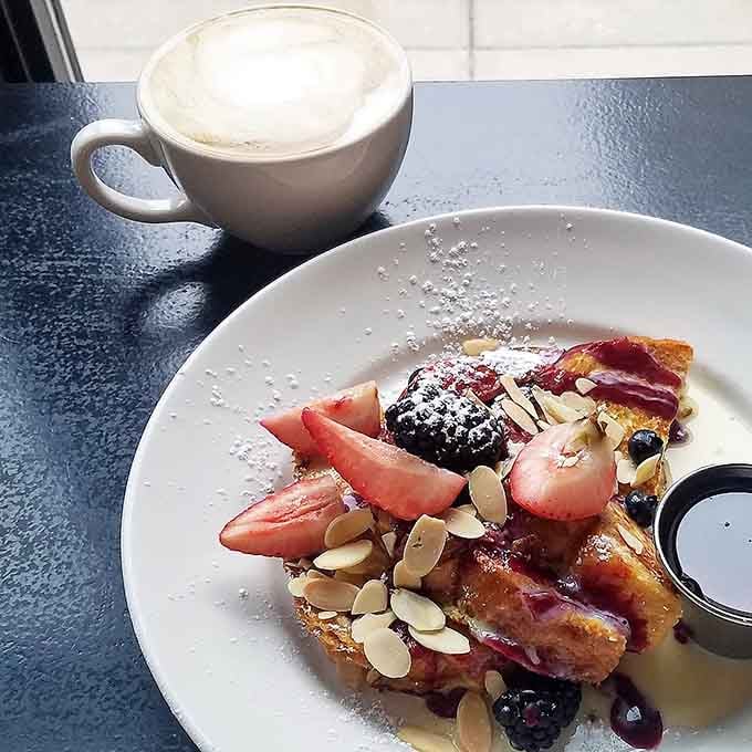French toast topped with fresh berries and sliced almonds looks like something from a food magazine, but tastes even better than it photographs.