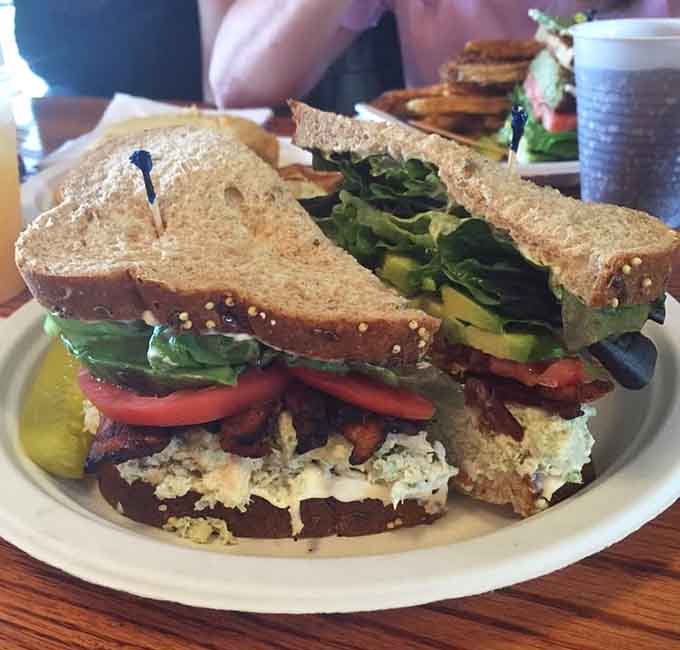 This sandwich is stacked so high it requires engineering skills just to figure out the eating strategy.
