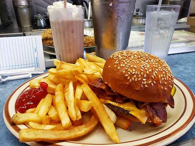 A bacon cheeseburger this loaded with a chocolate shake backup plan is the kind of life decision your cardiologist questions but your soul celebrates.