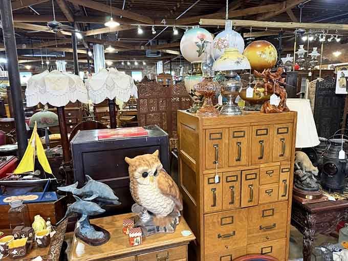 Vintage lamps and owl figurines share space in a delightfully eclectic arrangement that somehow just works perfectly.