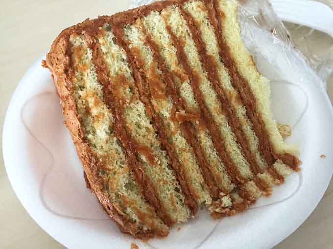 That towering caramel cake has more layers than a soap opera plot, and it's infinitely more satisfying to experience.