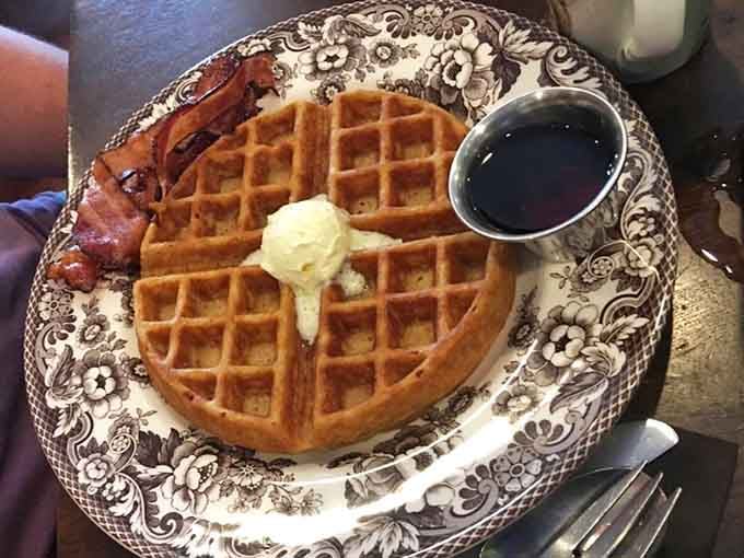 The Belgian waffle achieves that perfect golden-brown crispness while staying fluffy inside, a textural miracle worth celebrating every bite.