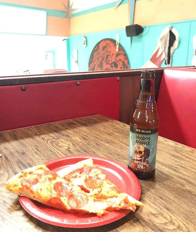 Pizza and craft beer on a red plate, because some combinations are timeless for good reason.