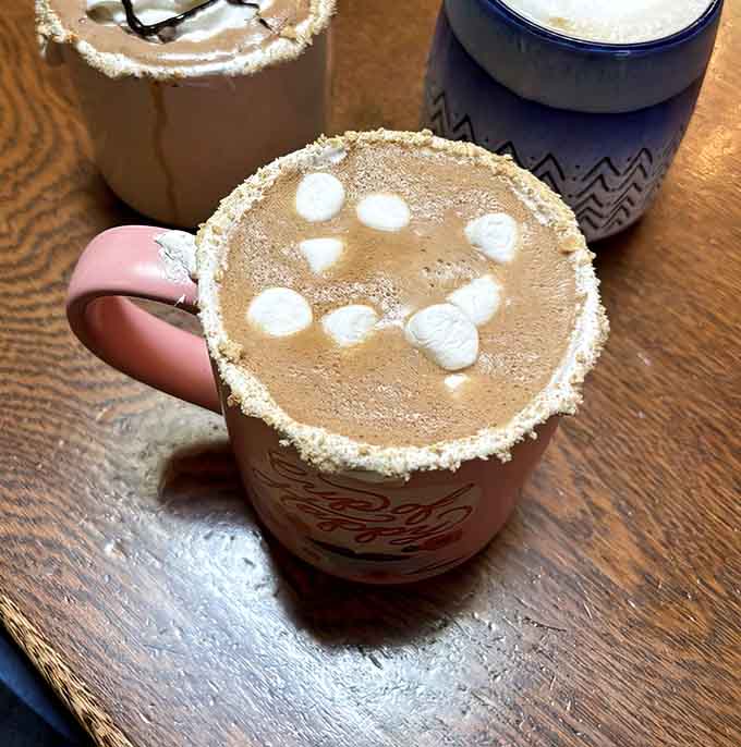 That s'mores mocha with marshmallows floating on top is basically childhood nostalgia in a mug.